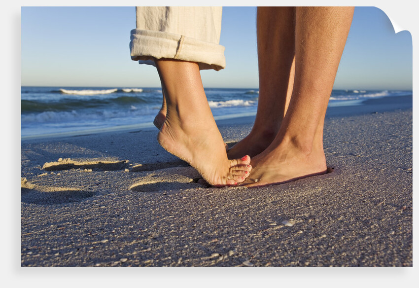 Feet of couple hugging on beach posters & prints by Corbis