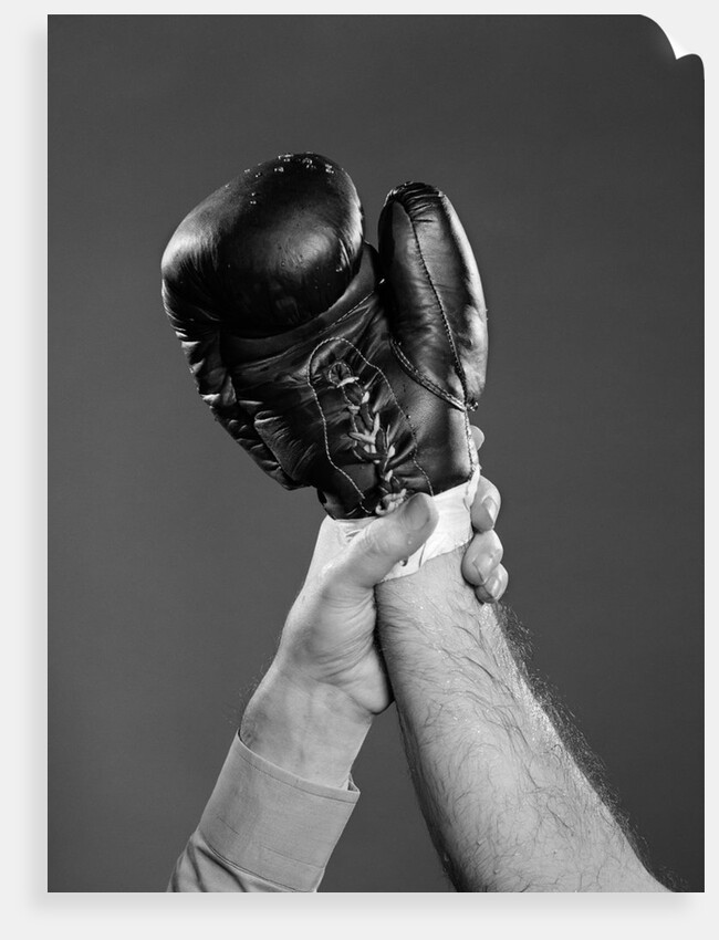 1950s gloved hand of winner of boxing match being held up by referee ...